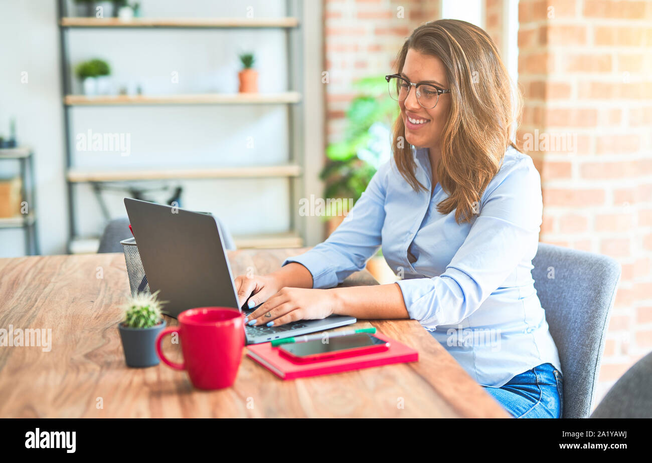 Young business woman sitting at desk working using computer laptop ...