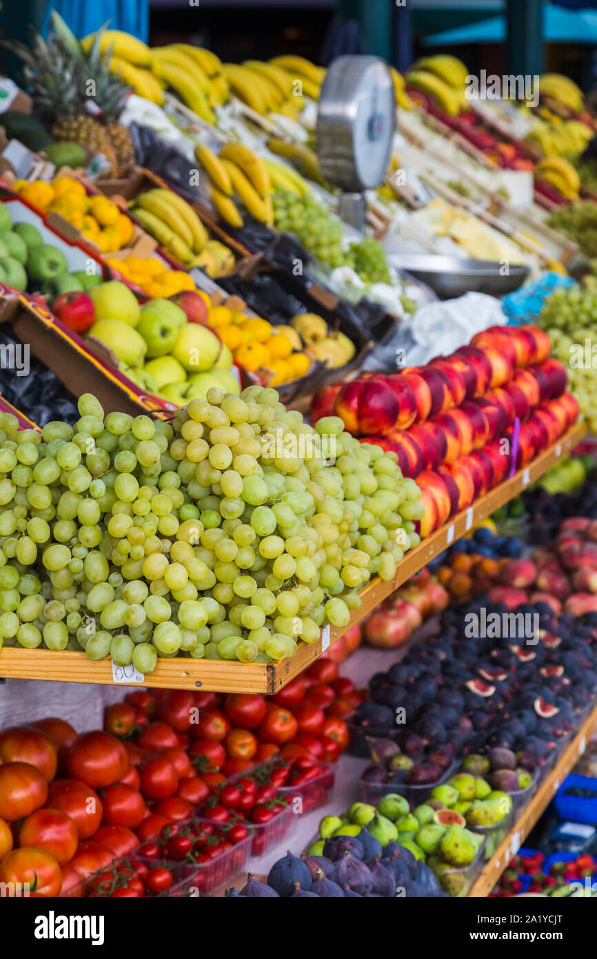 Fresh fruit piled high on shelves on a market stall in Rovinj, Croatia ...