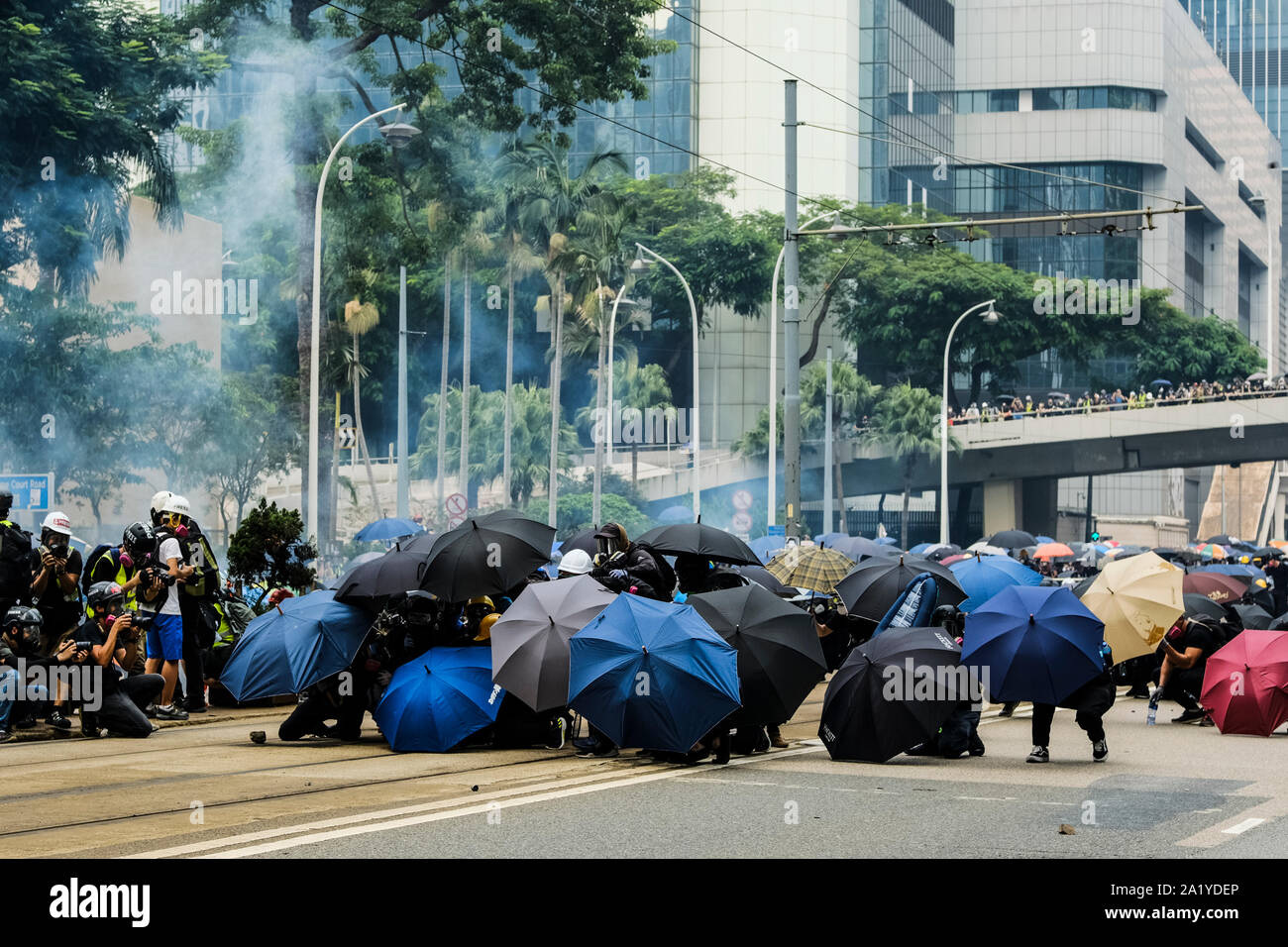 Protesters shield themselves with umbrellas during the demonstration ...