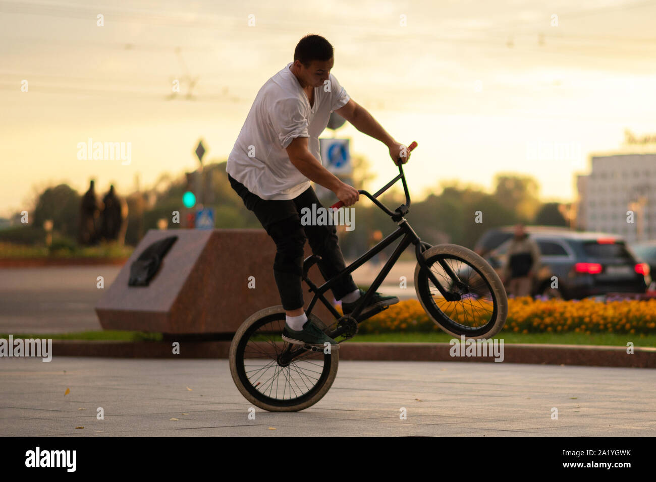 The guy performs a BMX stunt while standing on the rear wheel Stock ...