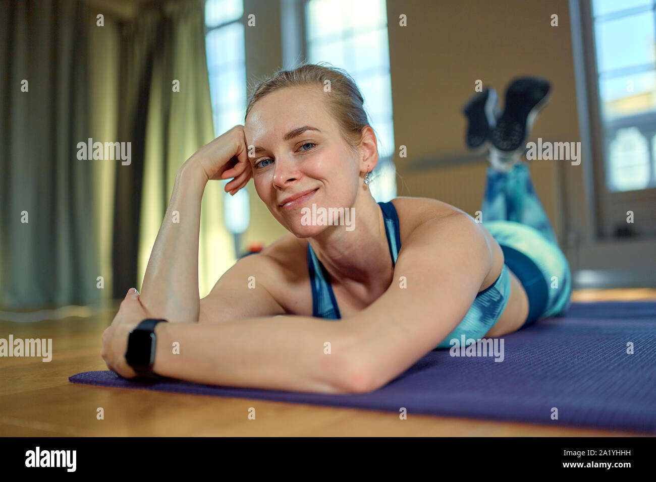 Beautiful portrait of young woman relaxing form exercise during a break ...