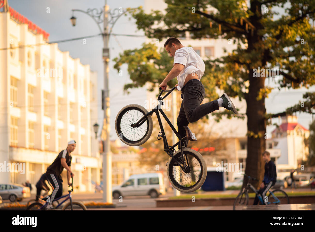 The guy performs a stunt on the BMX, jumping from the parapet high up ...