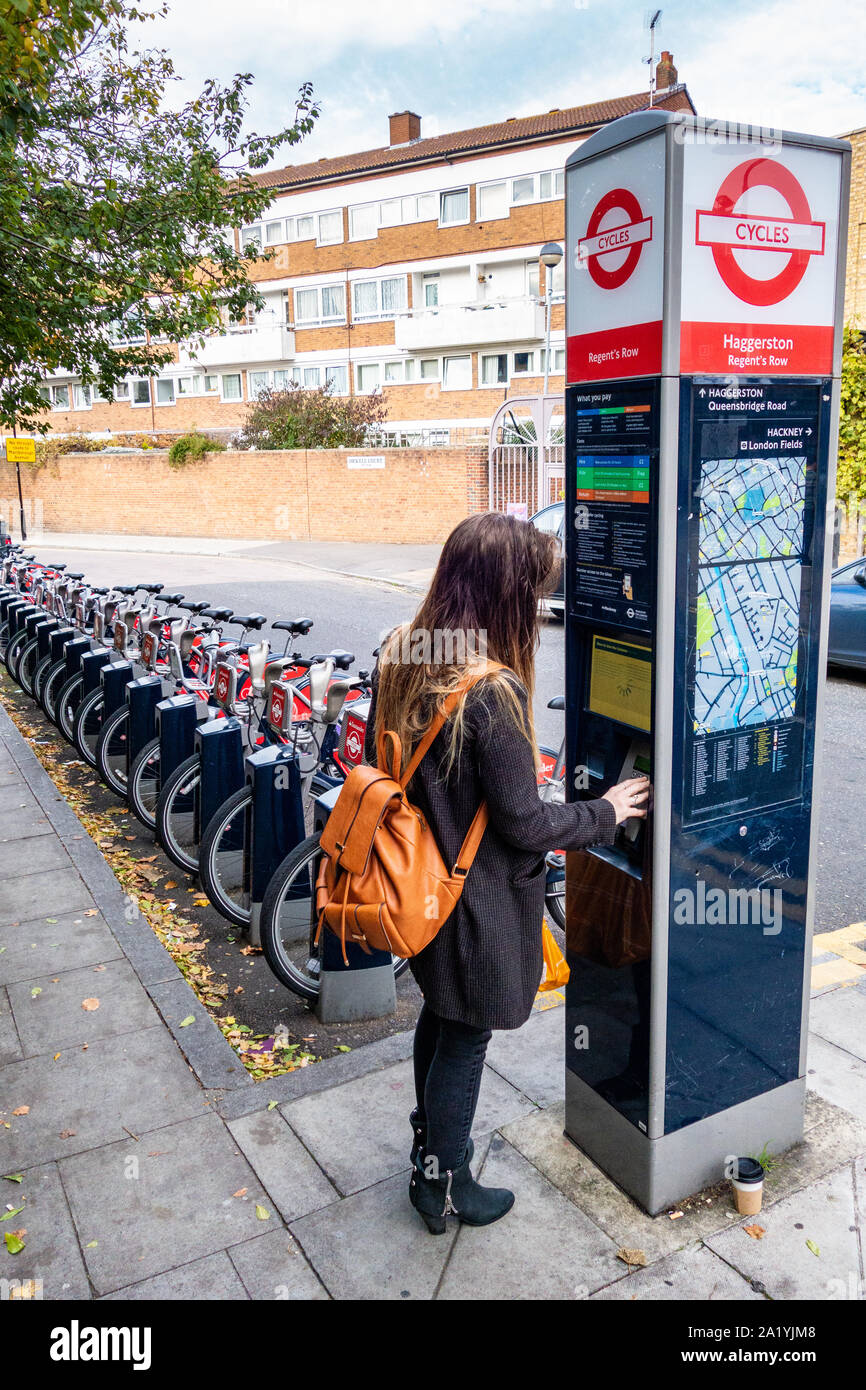 Woman paying automated bike hire hi-res stock photography and images ...