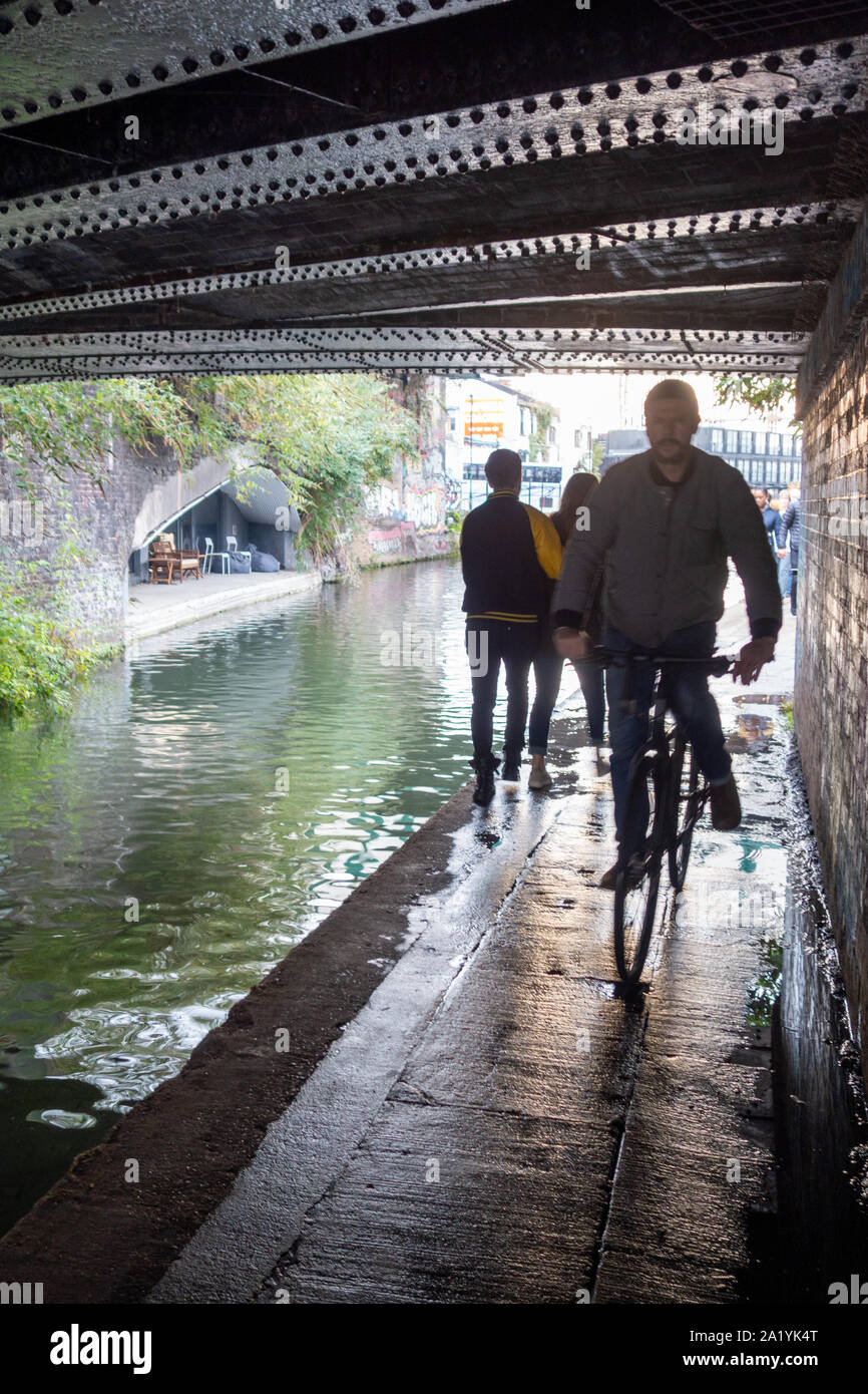 Cyclist and walkers under bridge over canal hi-res stock photography ...