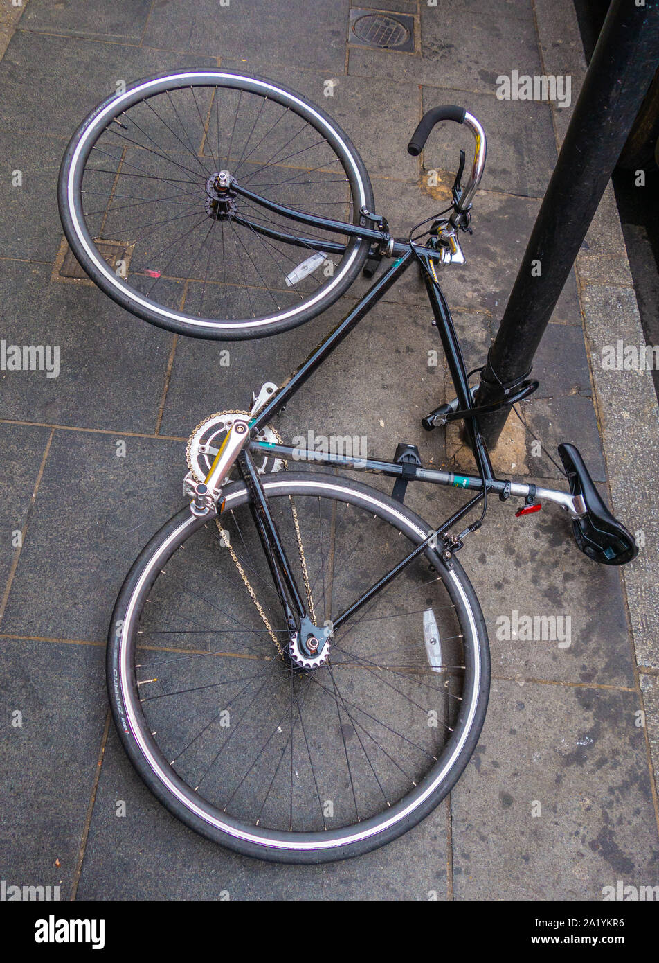 locked up pushbike, cycle laying on its side in a london street Stock ...