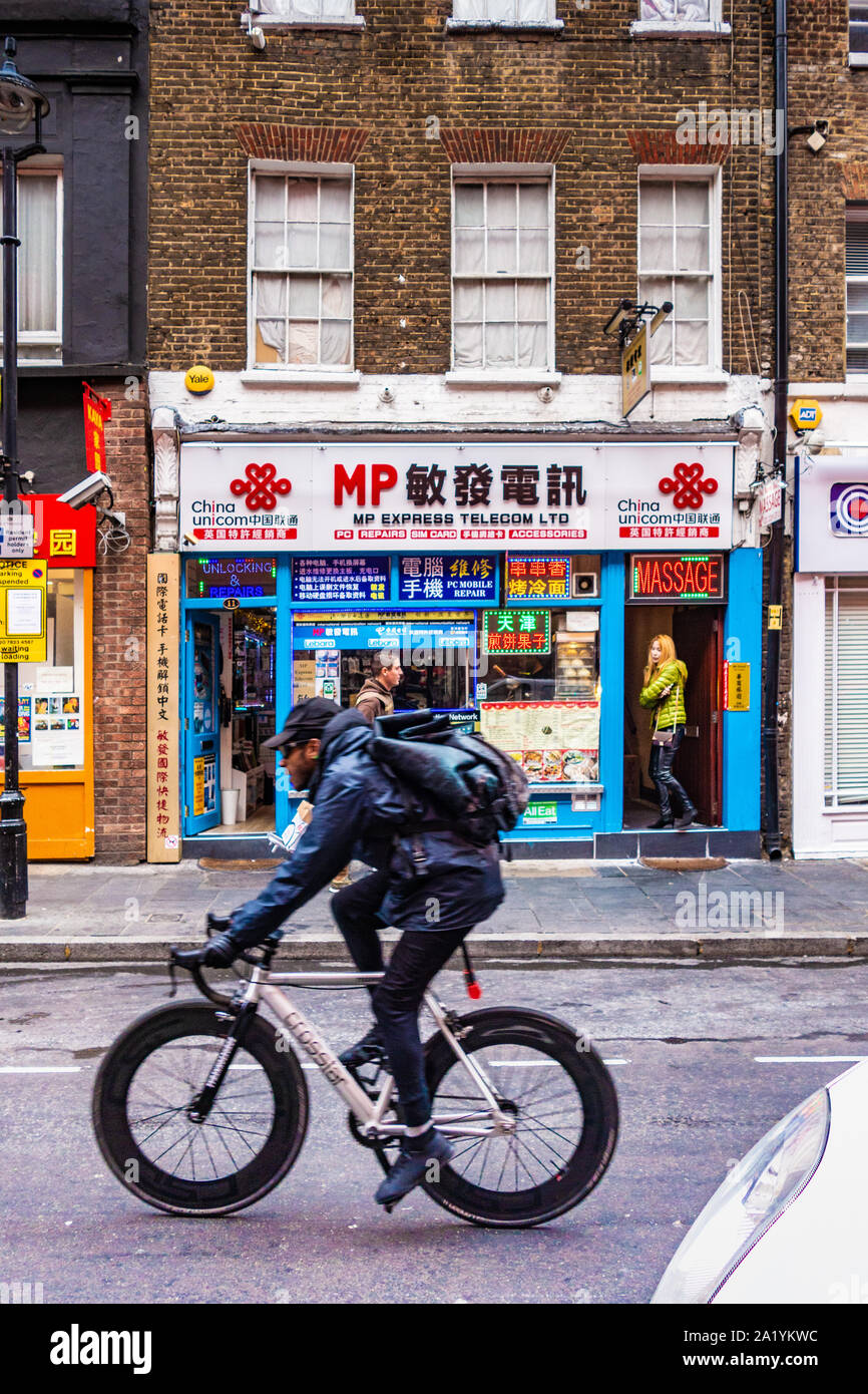 man riding riding a pushbike along a london street Stock Photo - Alamy