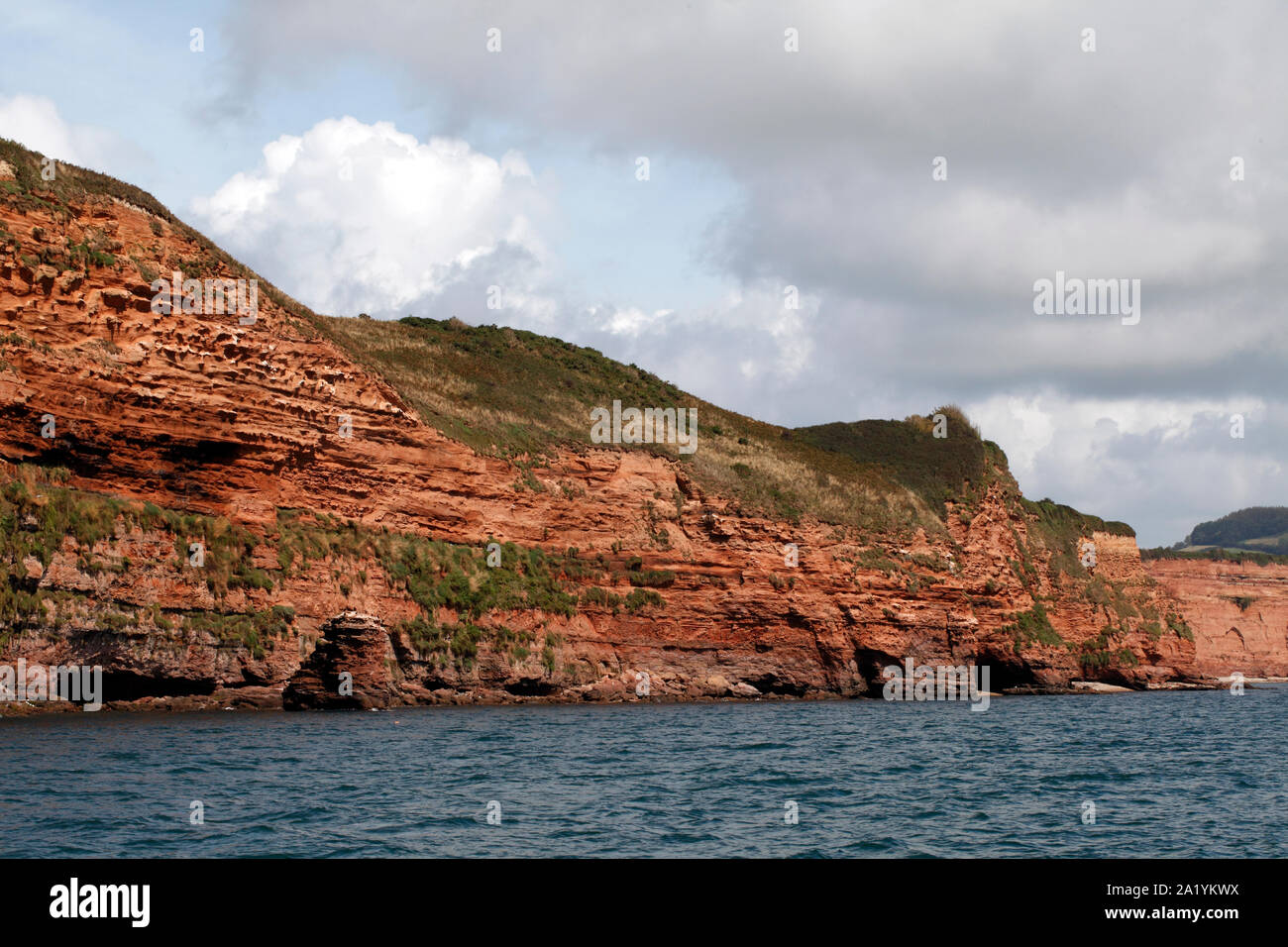 Towering red sandstone cliffs on the East Devon coast. UK. Rock, strata ...