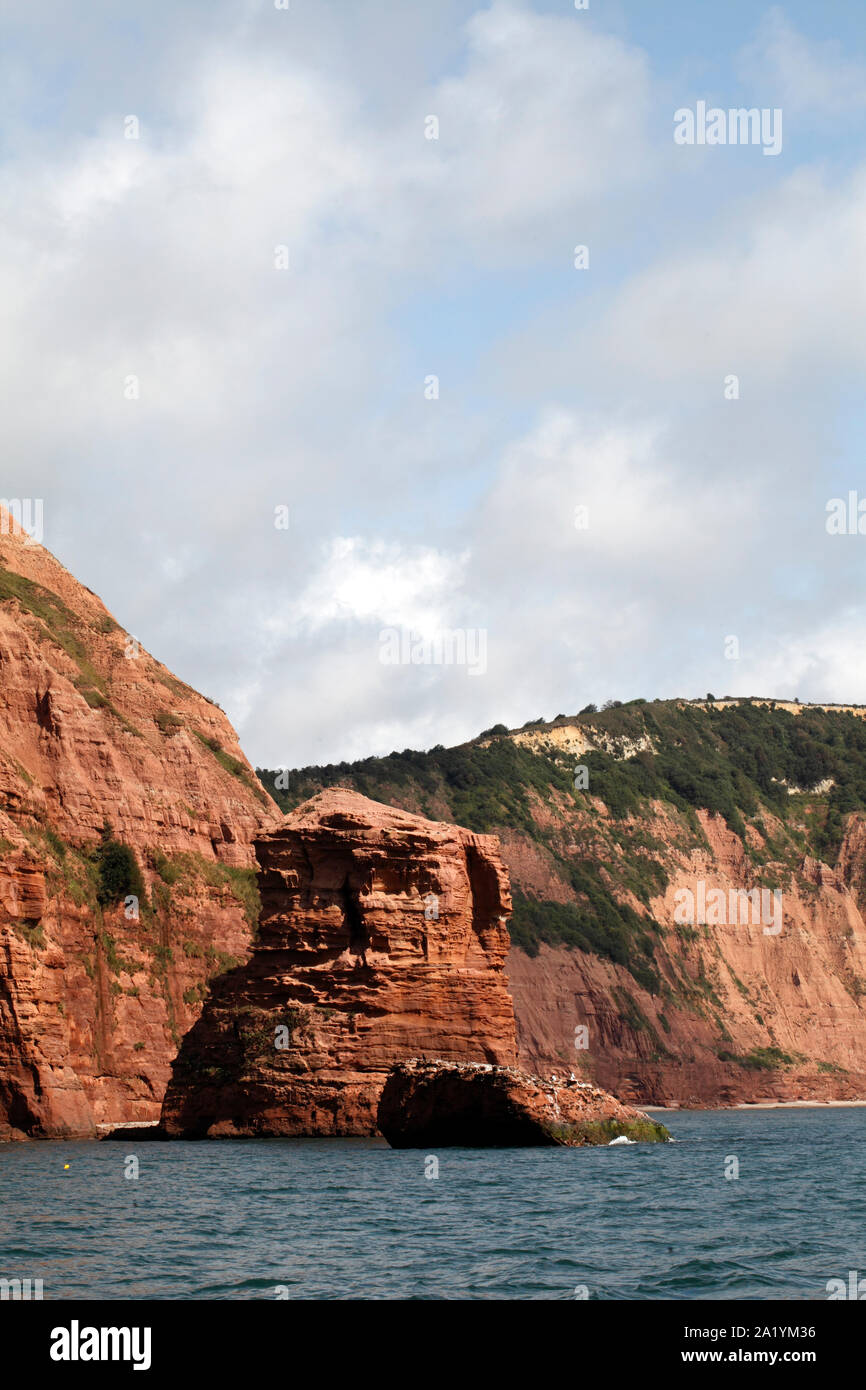 Towering red sandstone Pillar and cliffs on the East Devon coast. UK ...