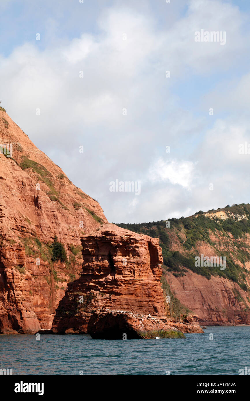 Towering red sandstone Pillar and cliffs on the East Devon coast. UK ...