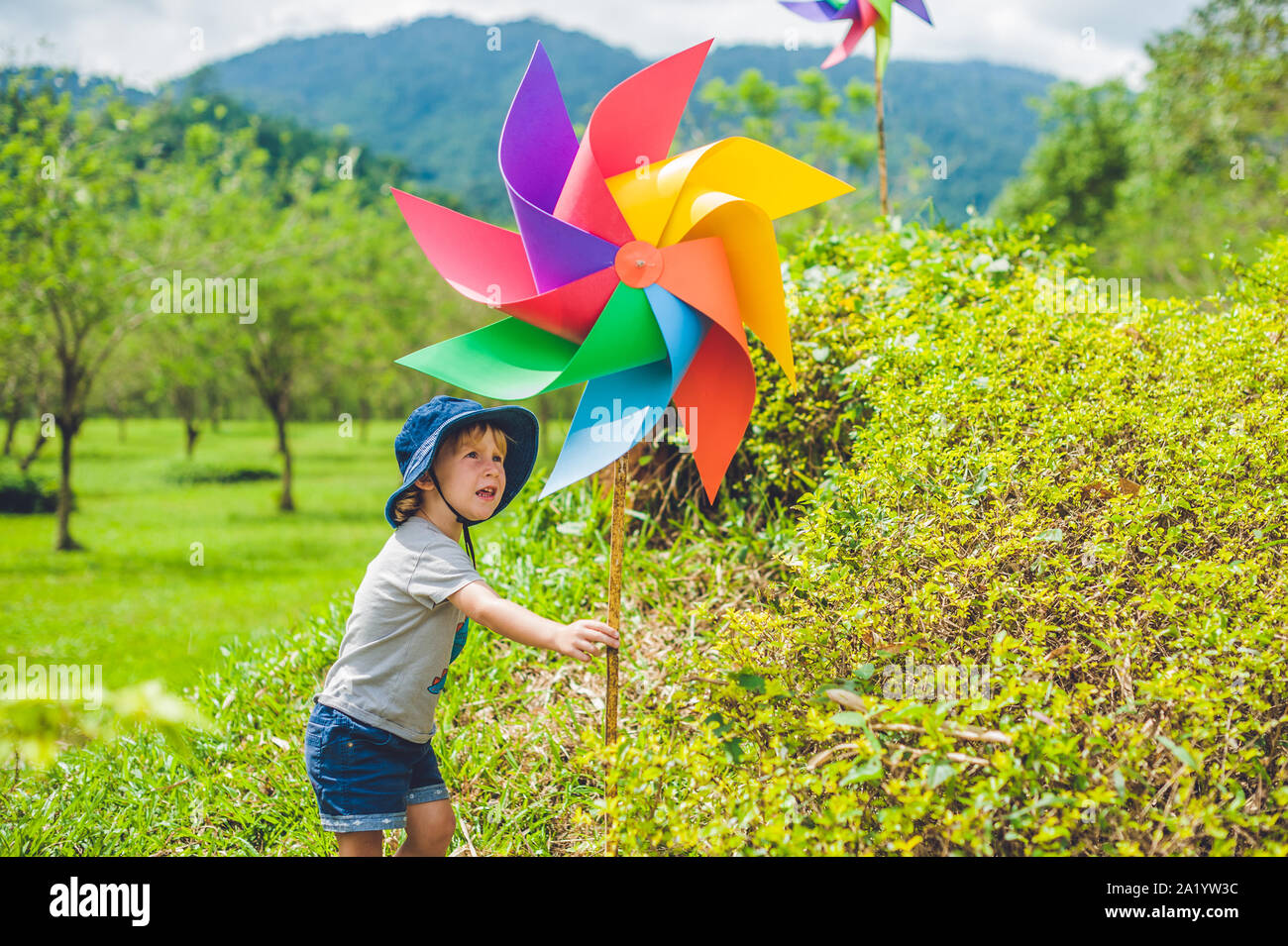 Cute little boy and a pinwheel windmill Stock Photo - Alamy