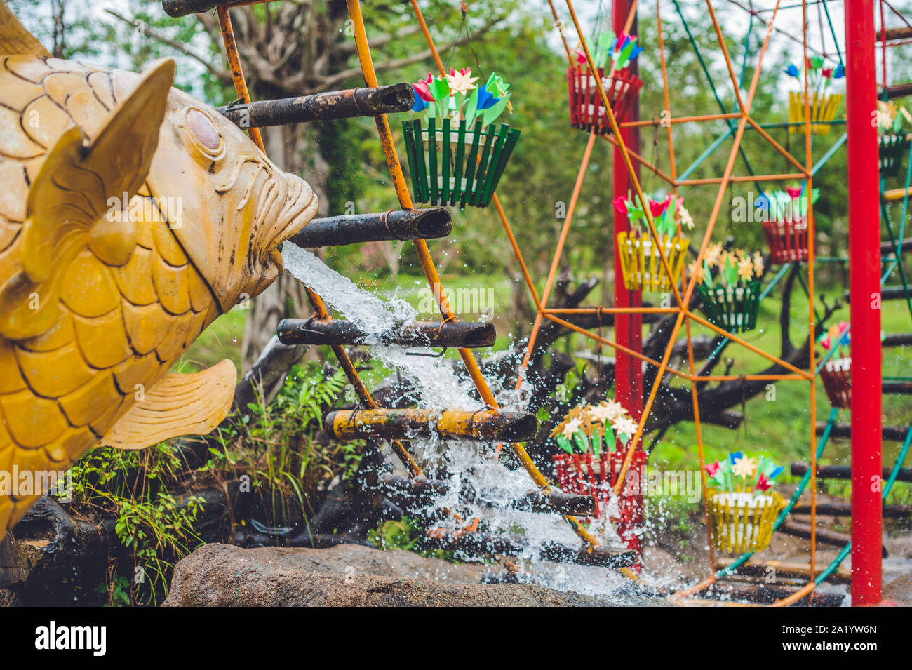 Waterwheel and fish. Resort Park concept Stock Photo - Alamy