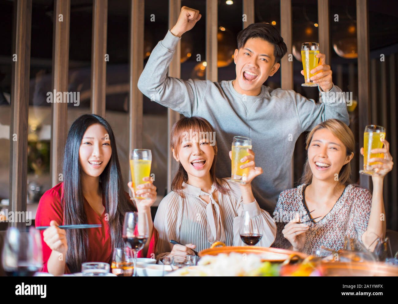 young friends having fun in hot pot restaurant Stock Photo - Alamy