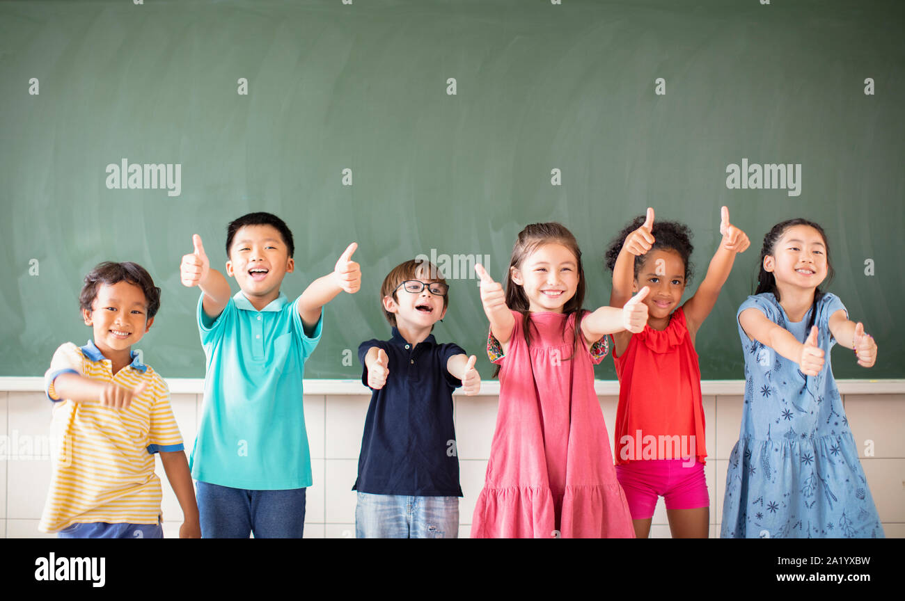 Multi-ethnic group of school children standing in classroom Stock Photo ...