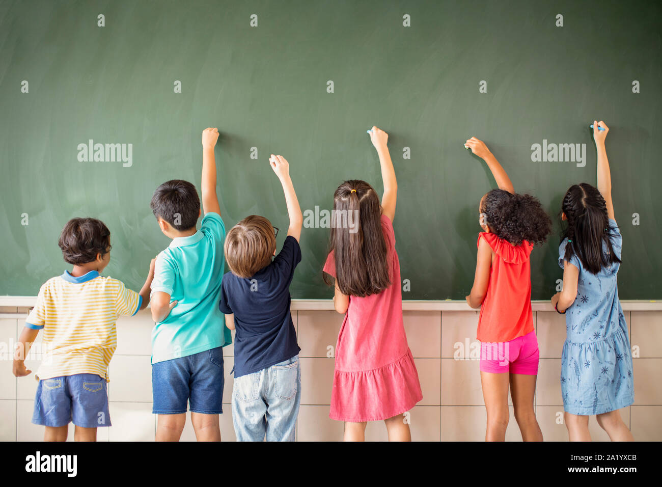 Multi-ethnic group of school children drawing on the chalkboard Stock ...