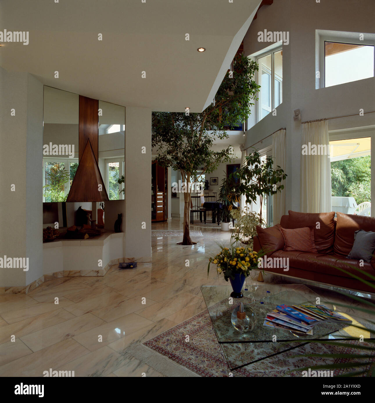 Central stove in open plan architectural living space Stock Photo - Alamy