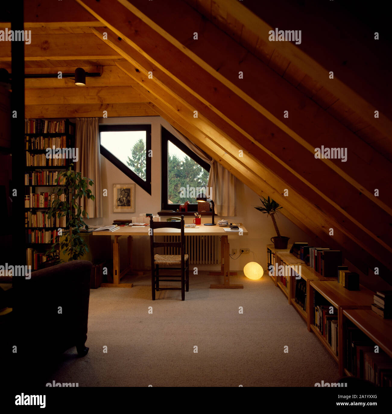 Working space under eaves in top of modern house Stock Photo - Alamy
