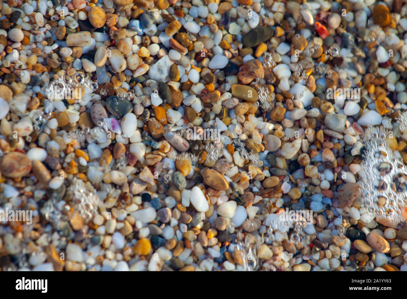 sea pebbles colored granite on the beach background stones. The shore ...