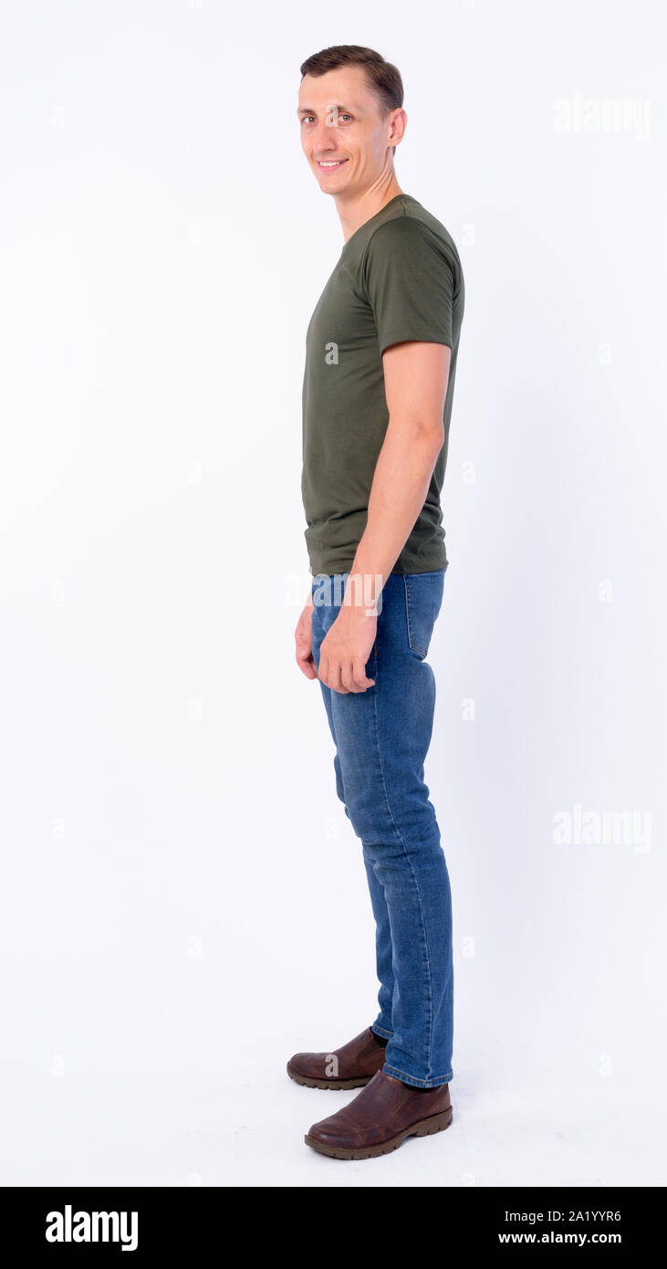 Full body shot profile view of happy man looking at camera Stock Photo ...