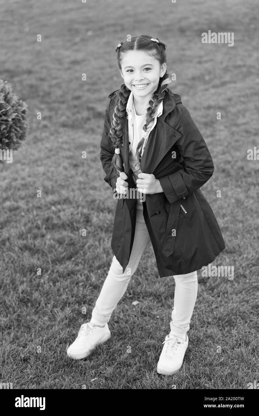 Fashionable coat. Girl cute face braided hair posing coat in spring ...