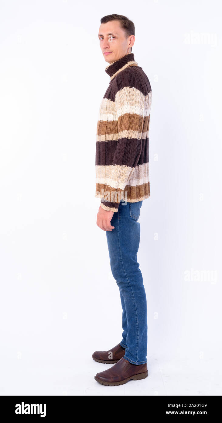 Full body shot profile view of man looking at camera ready for winter ...