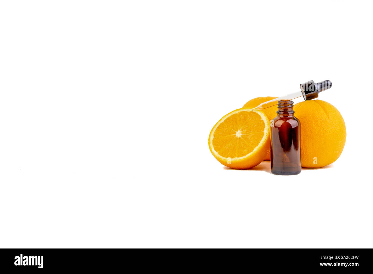 Vitamin C serum bottle with dropper and orange on white background ...