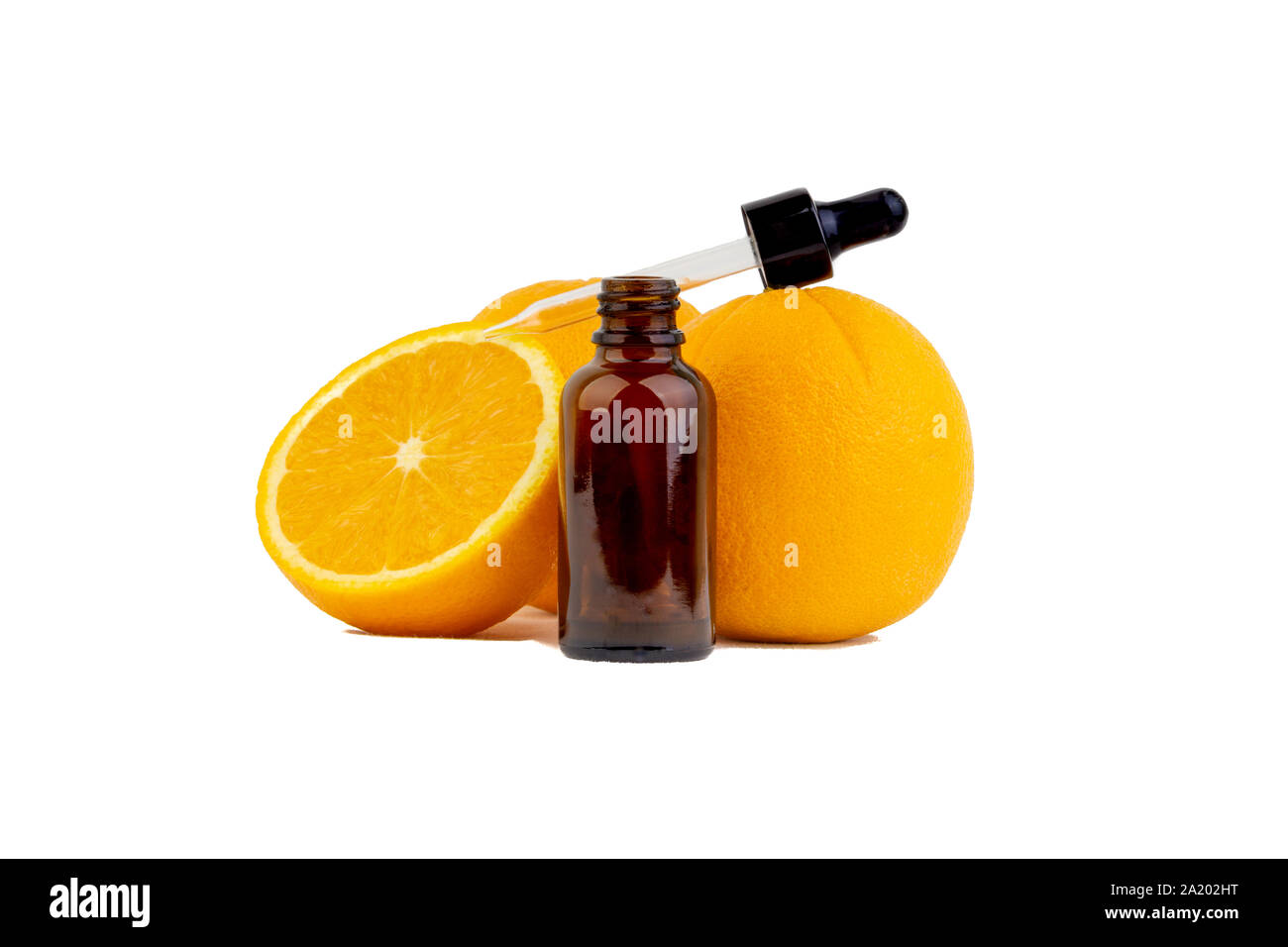 Vitamin C serum bottle with dropper and orange on white background ...