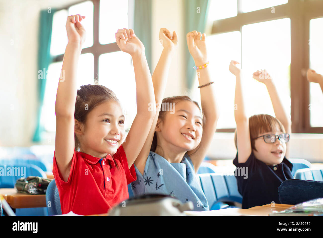 Smiling elementary school kids in classroom Stock Photo - Alamy