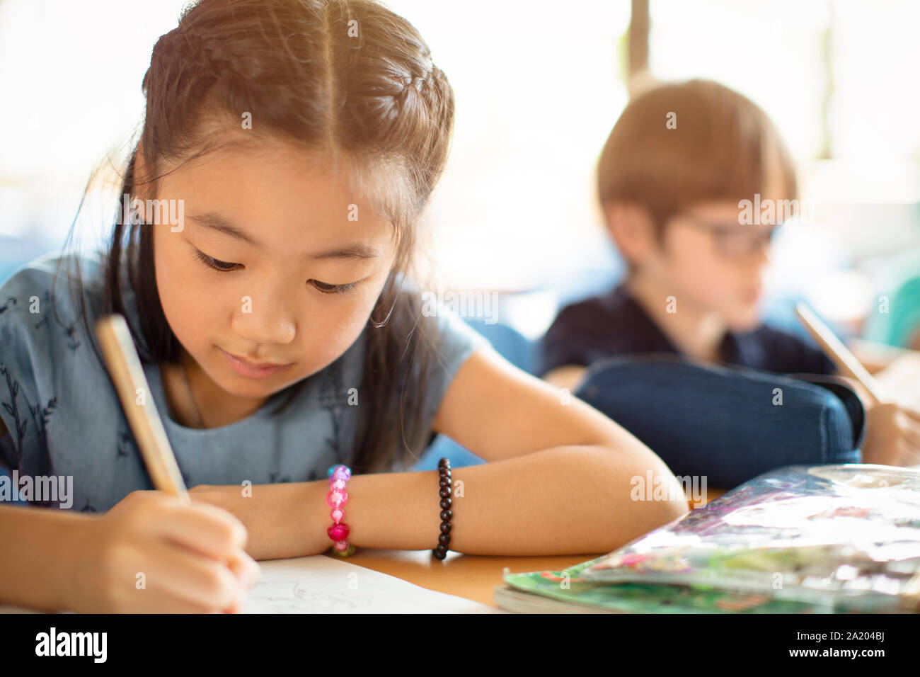 Smiling elementary school kids in classroom Stock Photo - Alamy