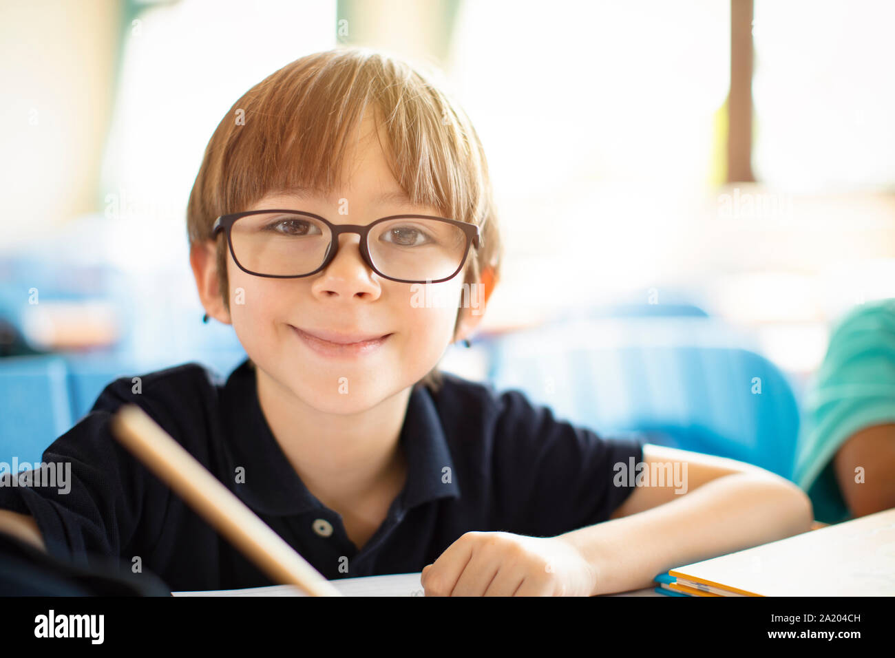 happy elementary school kids in classroom Stock Photo - Alamy