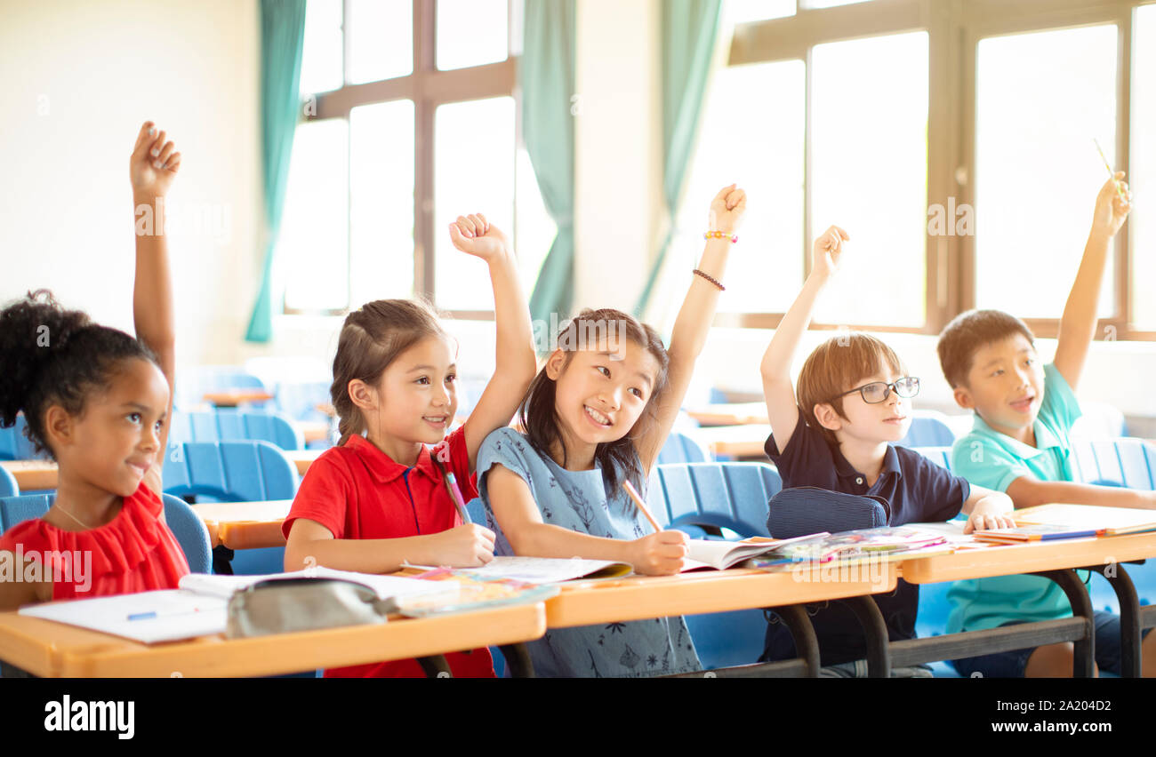 happy elementary school kids in classroom Stock Photo - Alamy