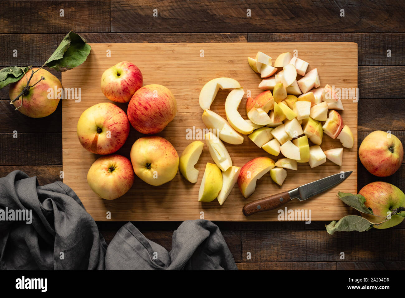 Diced red apple cubes on wooden cutting board. Preparation of apple pie ...