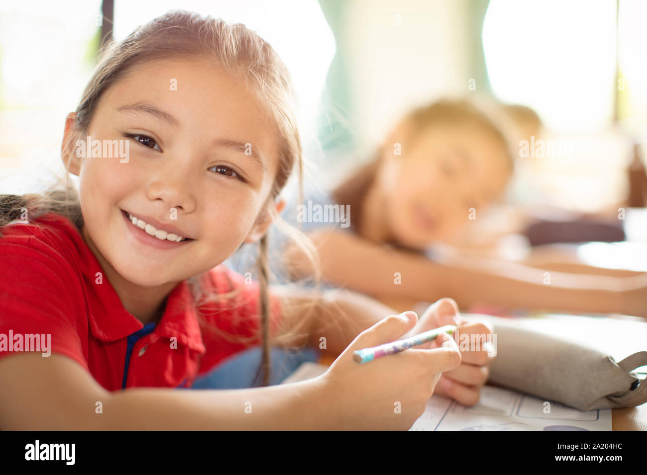 Smiling elementary school kids in classroom Stock Photo - Alamy