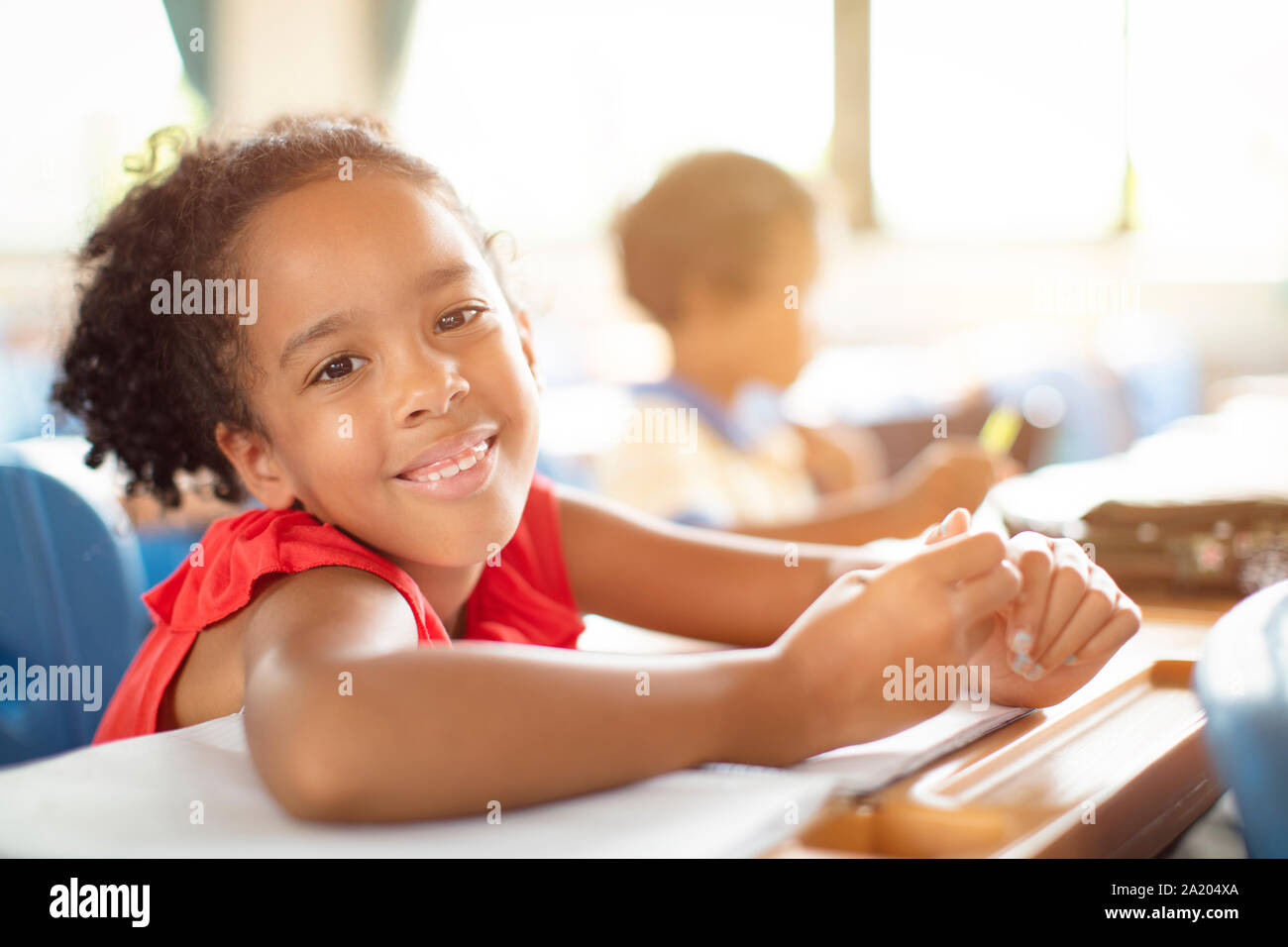 Smiling elementary school kids in classroom Stock Photo - Alamy