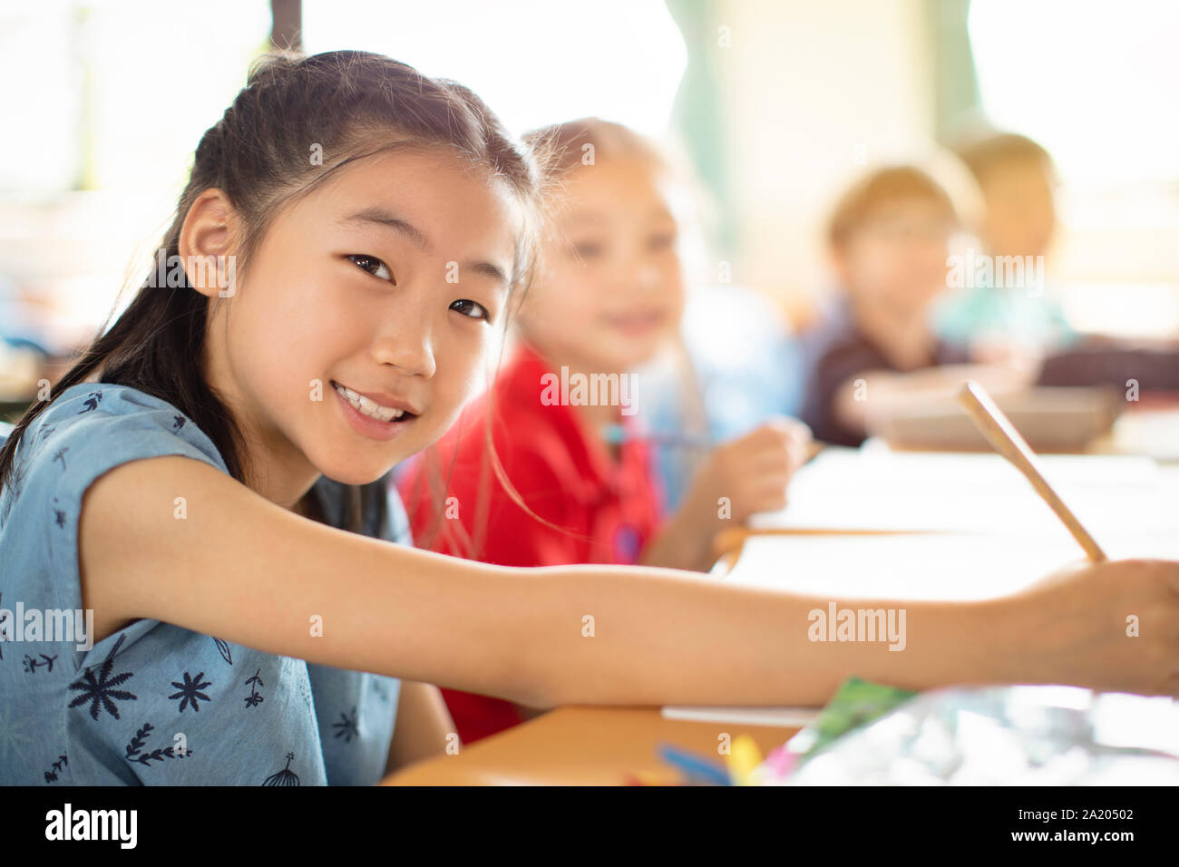 Smiling elementary school kids in classroom Stock Photo - Alamy