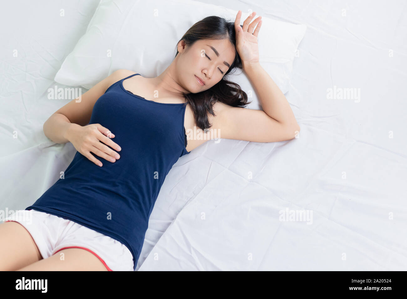 Asian woman lying and sleep on the bed top view Stock Photo - Alamy