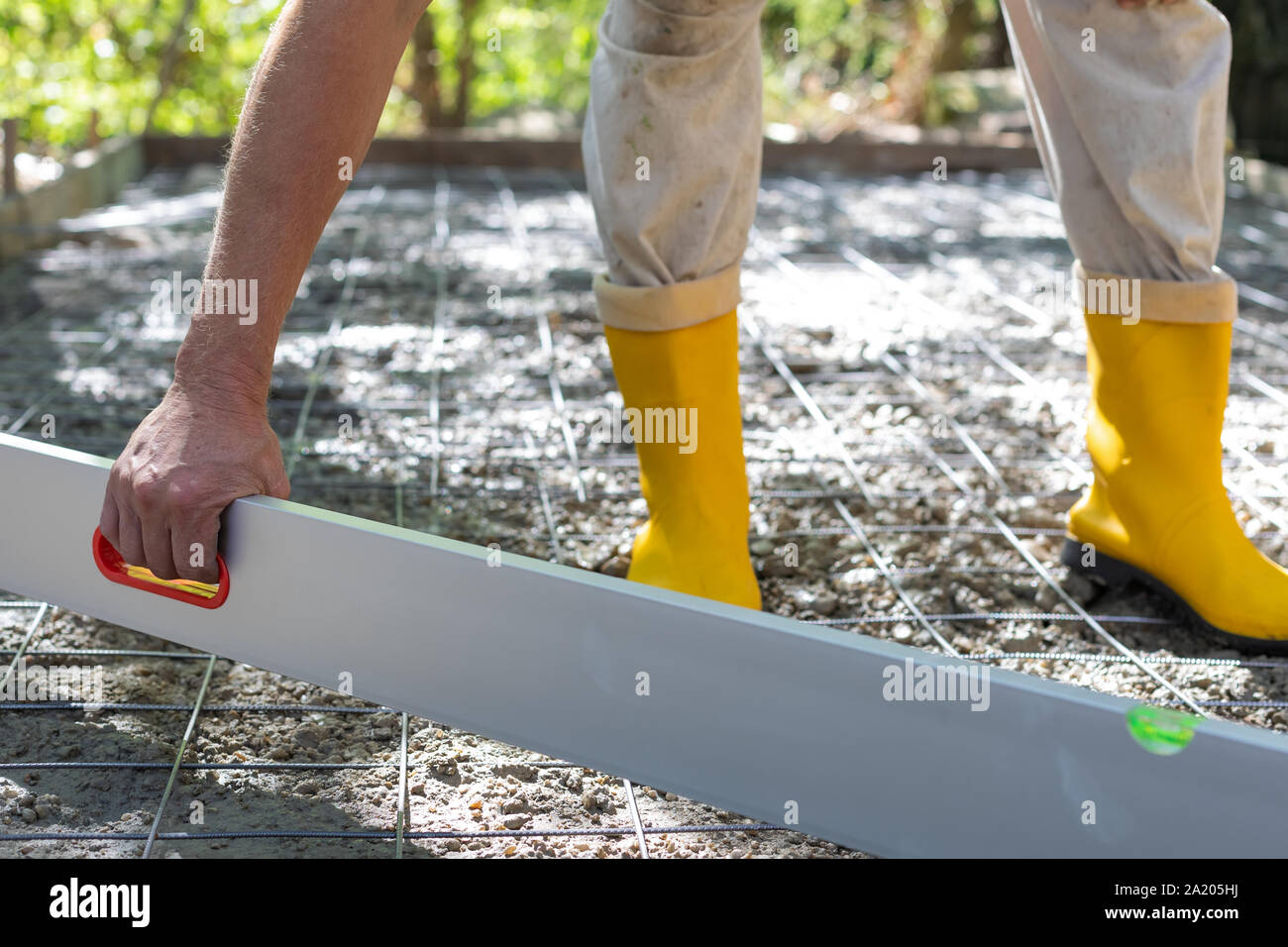 Construction worker in yellow rubber boots at the construction site ...