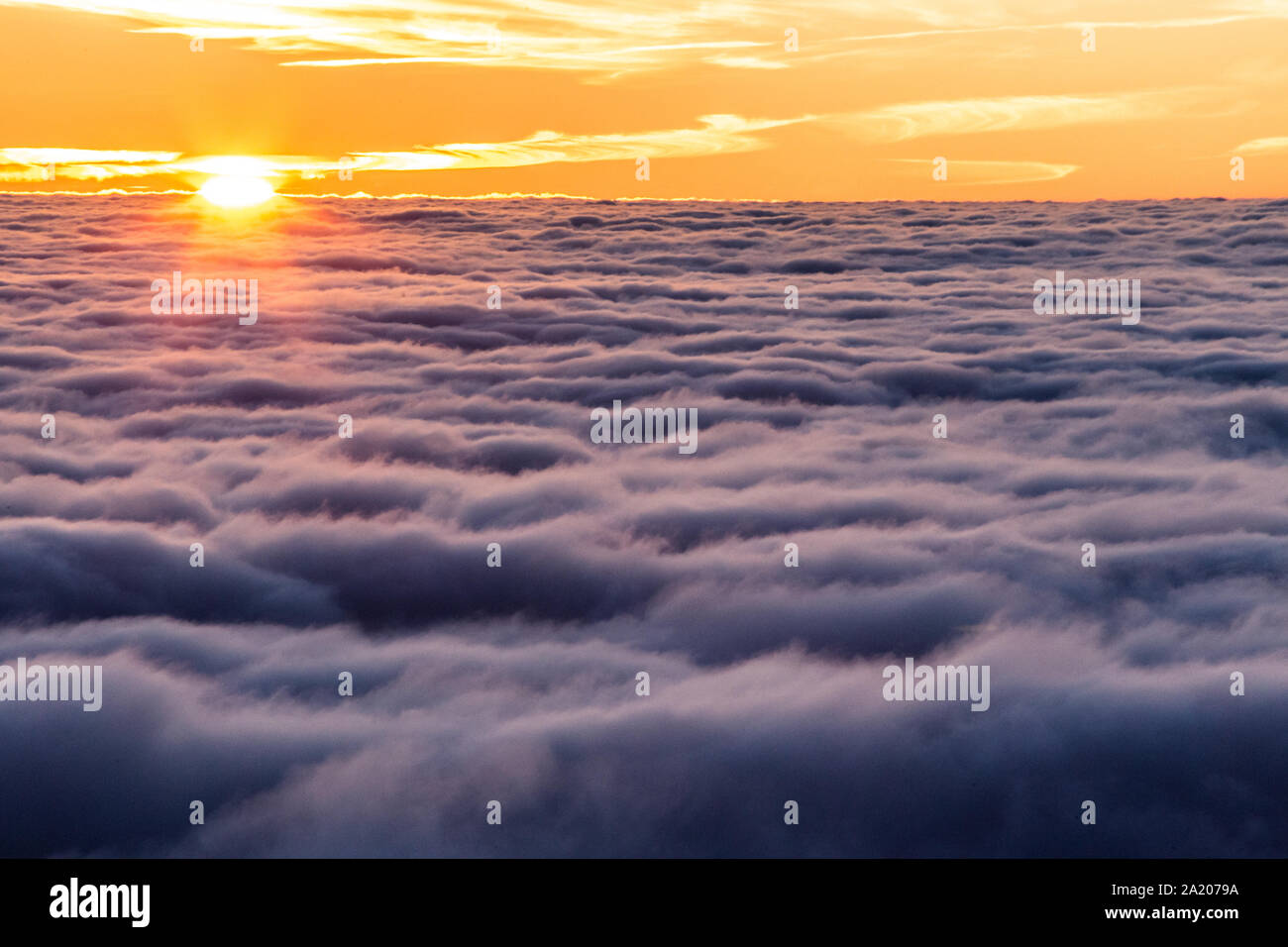 Beautiful sunset over a valley filled by fog Stock Photo - Alamy