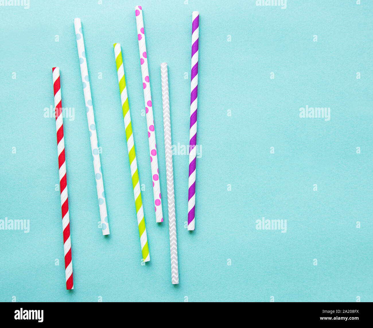 Drinking paper colorful straws for summer cocktails on light blue ...