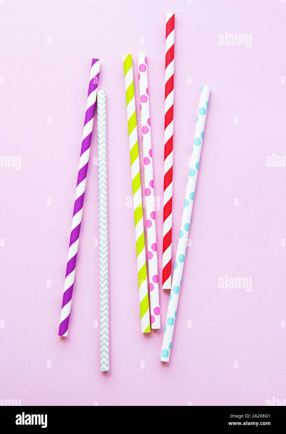Drinking paper colorful straws for summer cocktails on light pink ...