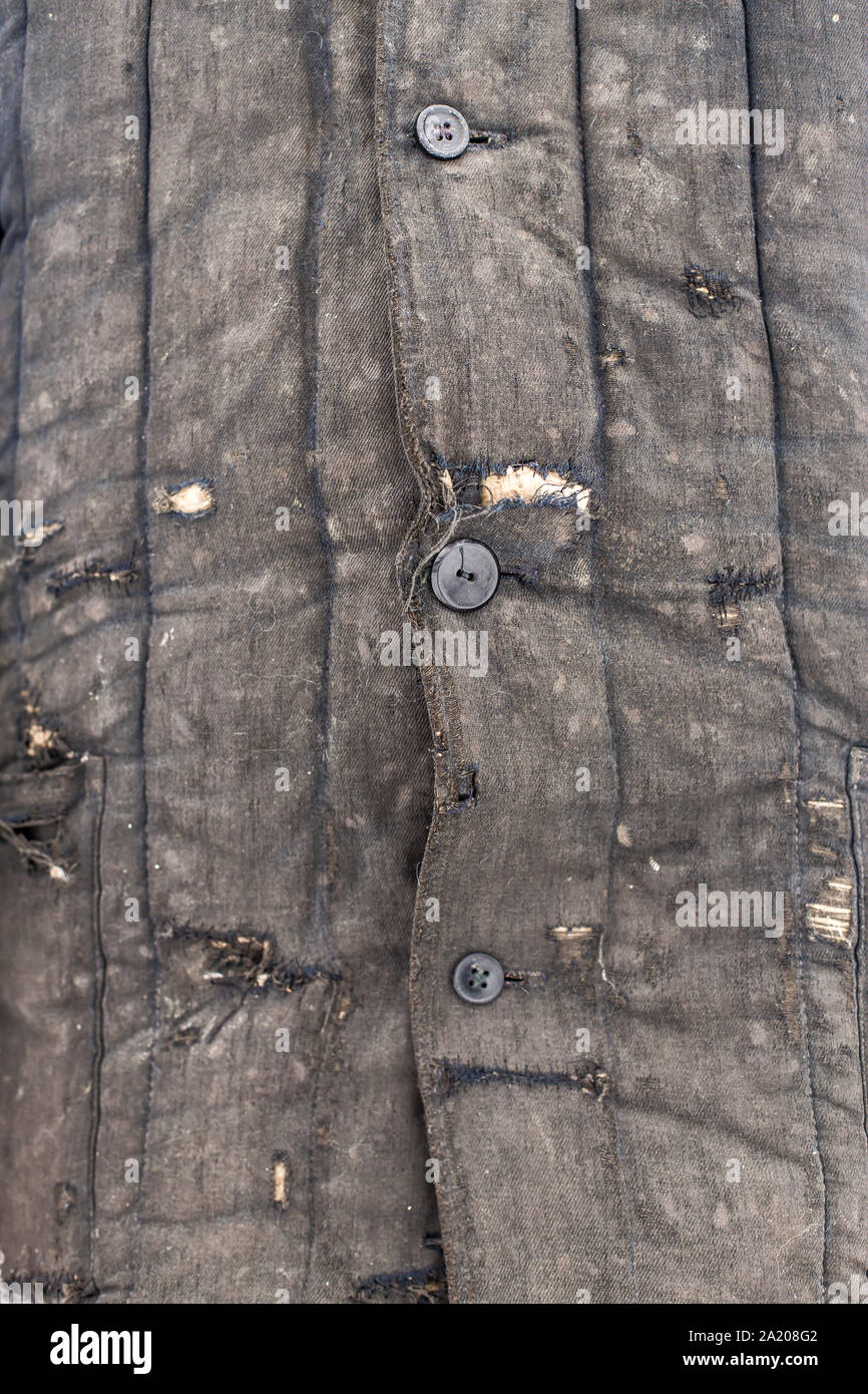 man dressed in shabby old worn working clothes with patches Stock Photo ...