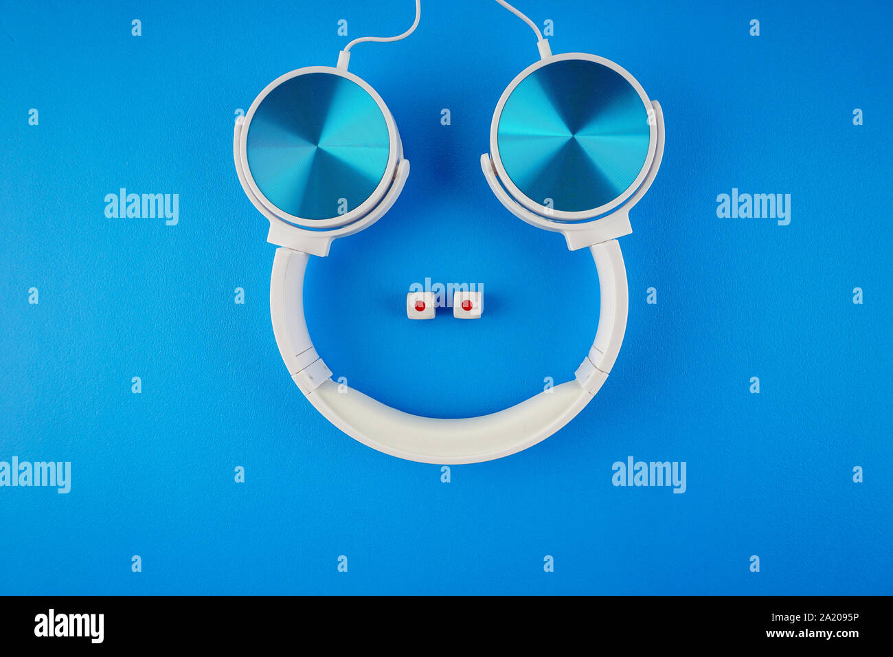 blue white color headphone on a blue background Stock Photo - Alamy