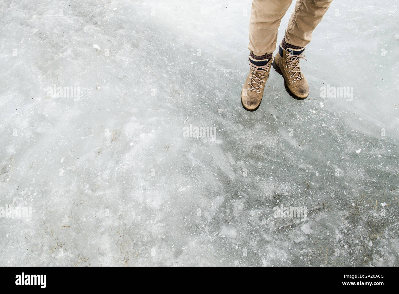 human legs dressed in hiking boots standing on ice Stock Photo - Alamy