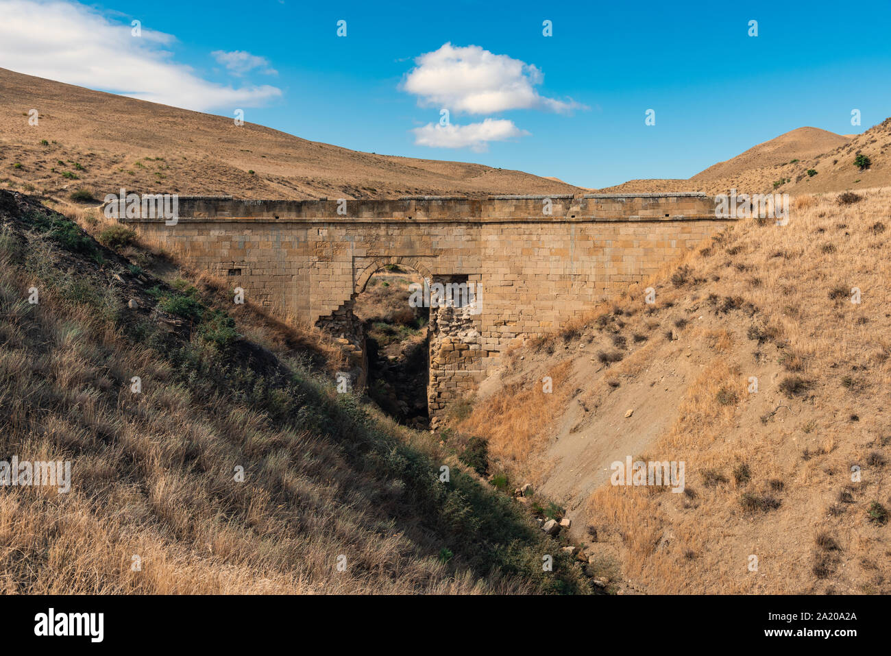 Old dilapidated stone bridge over a small mountain river Stock Photo ...