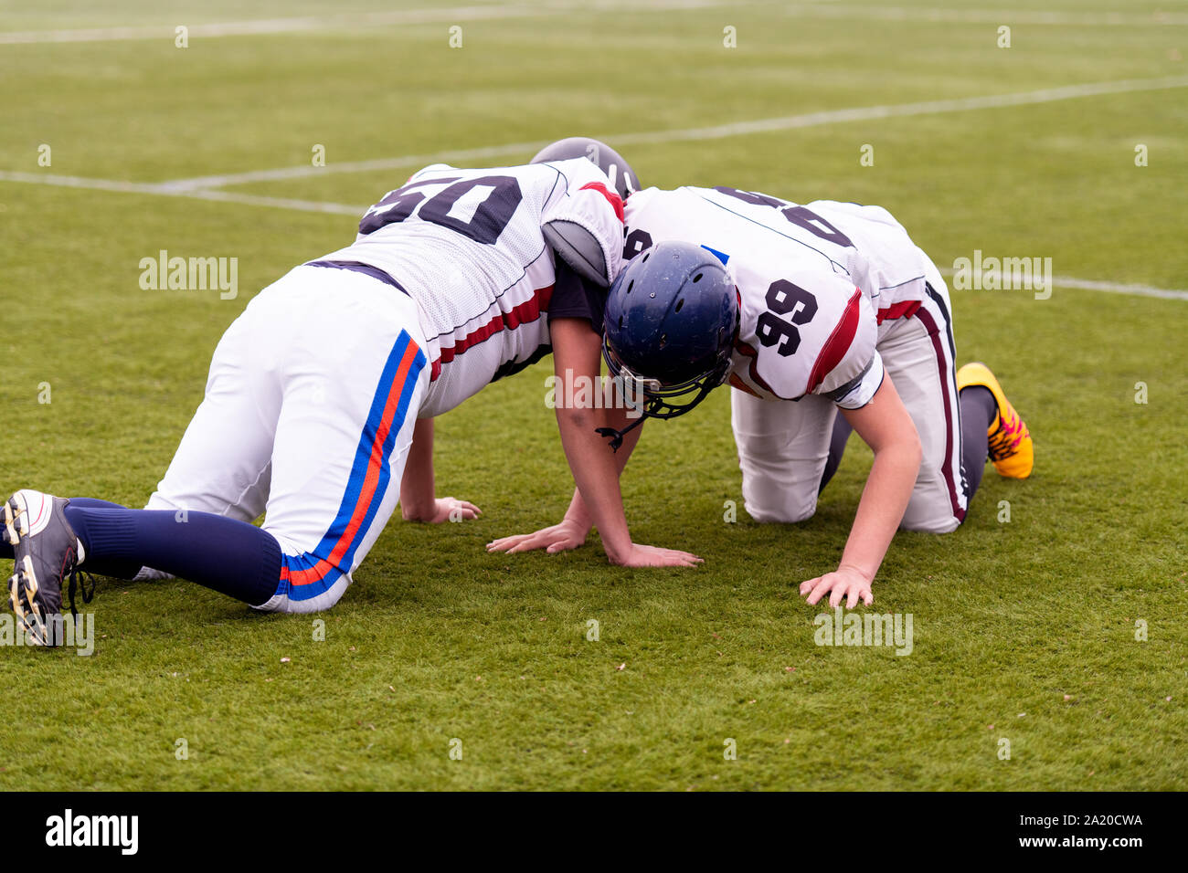 group of young professional american football players in action during ...