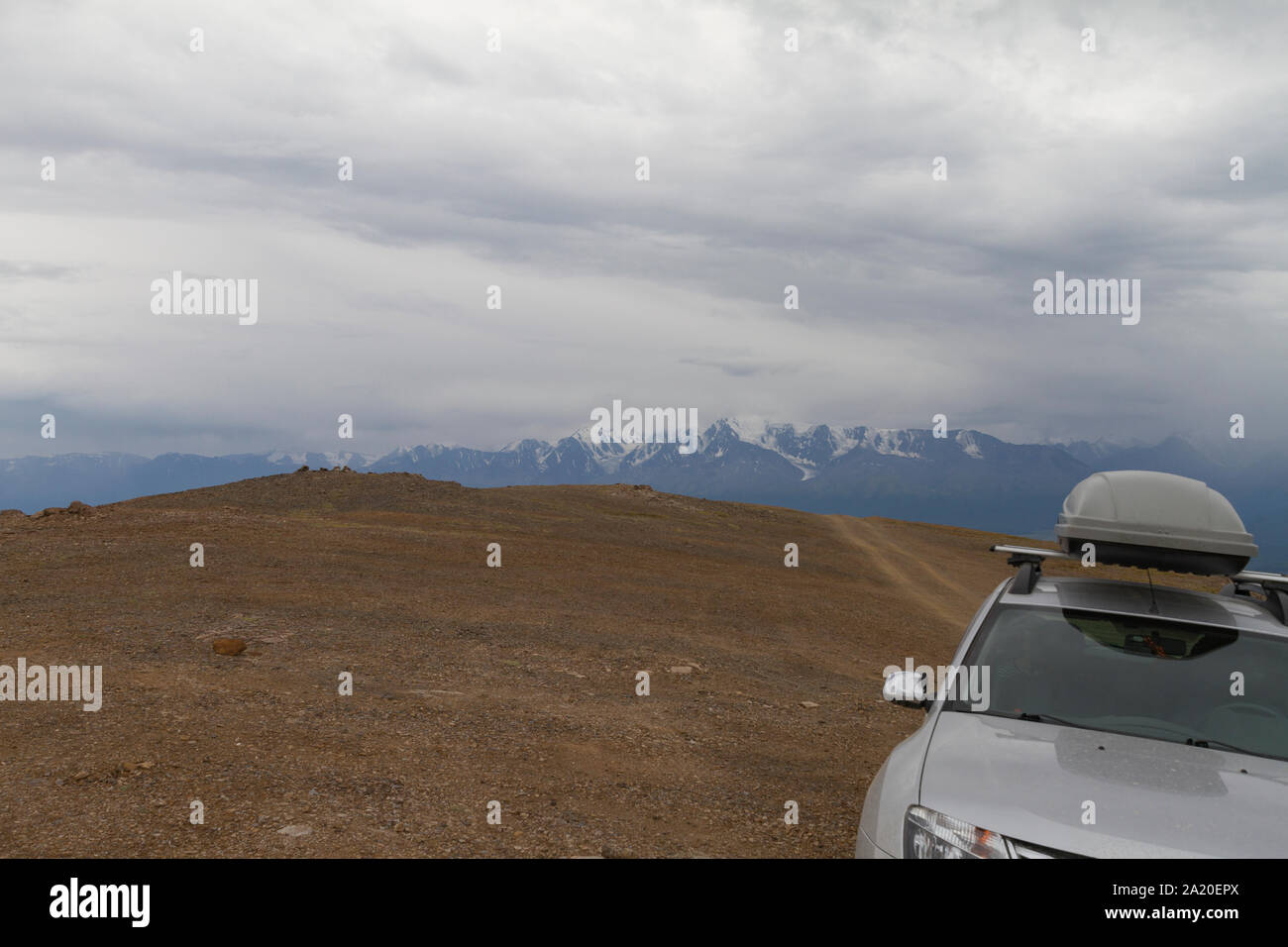 Car roof rack with light plastic cargo box for traveling. Mountain with ...