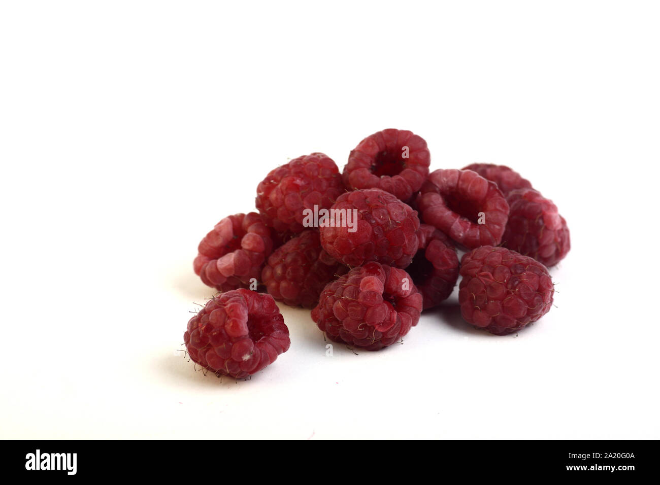 a pile of raspberry on white background Stock Photo - Alamy