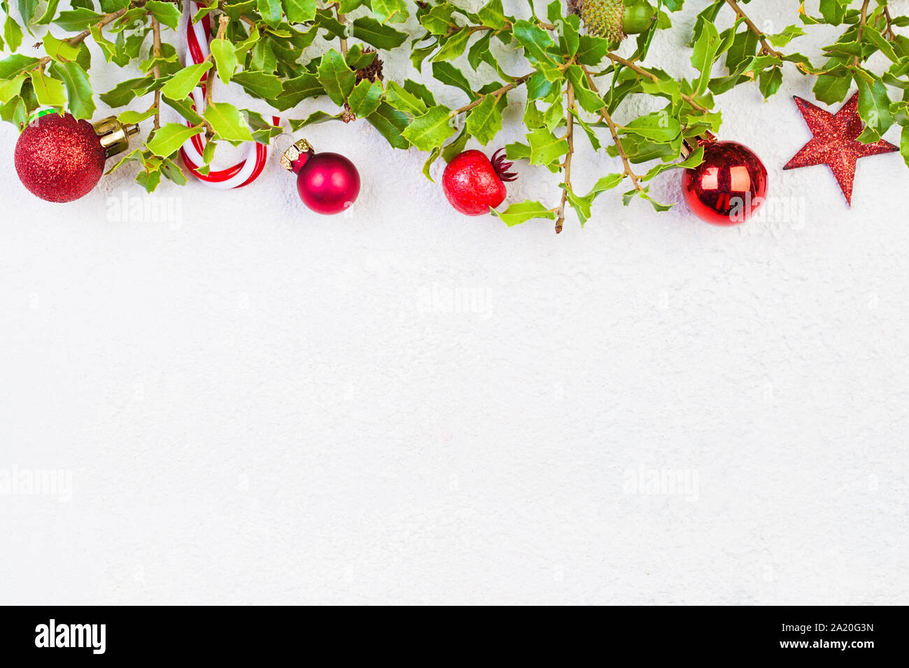 Christmas garland border on white plaster background Stock Photo - Alamy