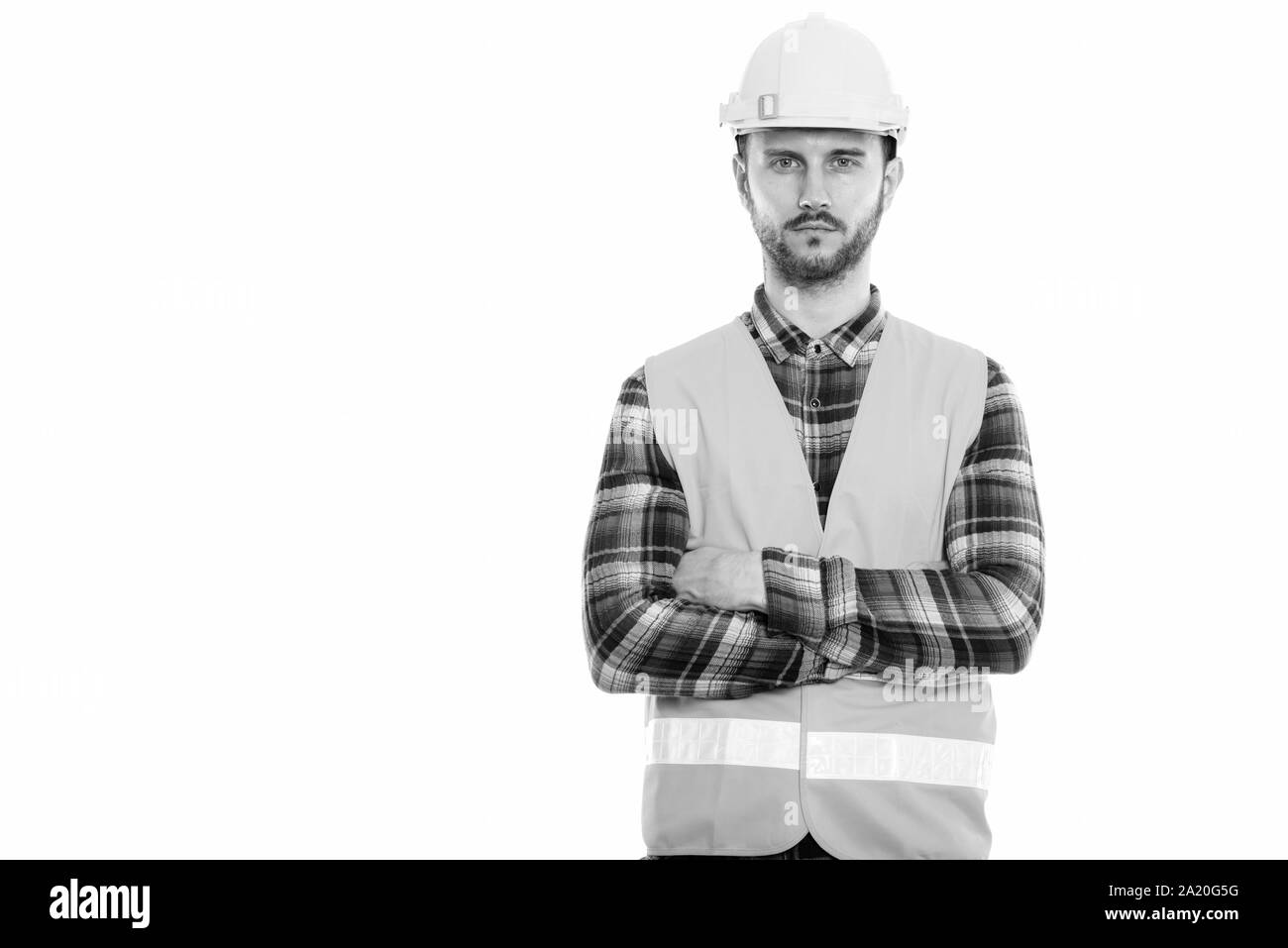 Studio shot of young man construction worker with arms crossed Stock ...