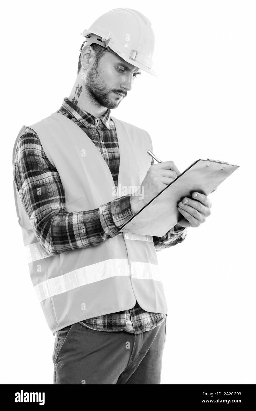 Studio shot of young man construction worker writing on clipboard Stock ...