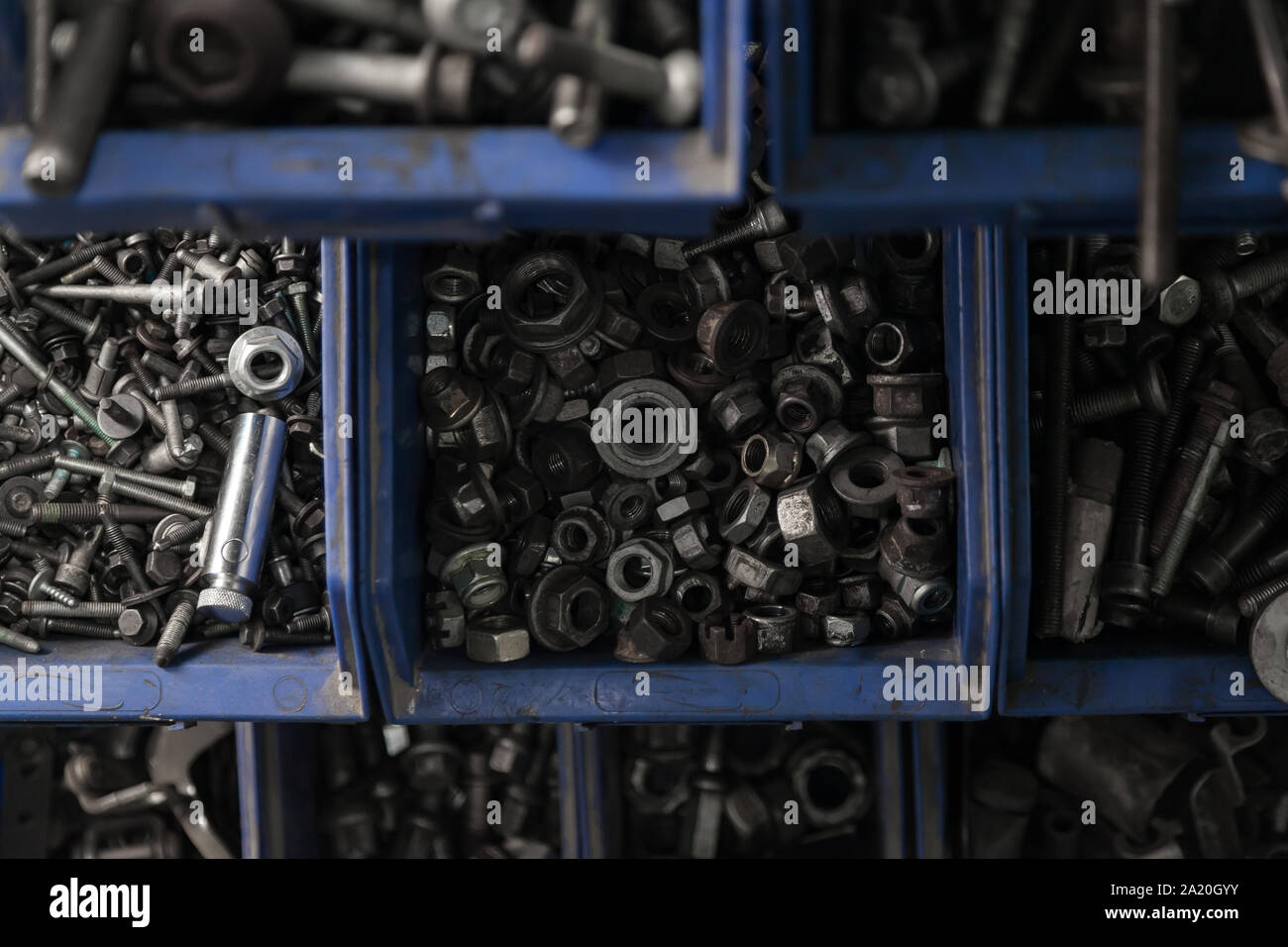 Plastic blue box with a bunch of nuts, bolts and screws. Tools and ...